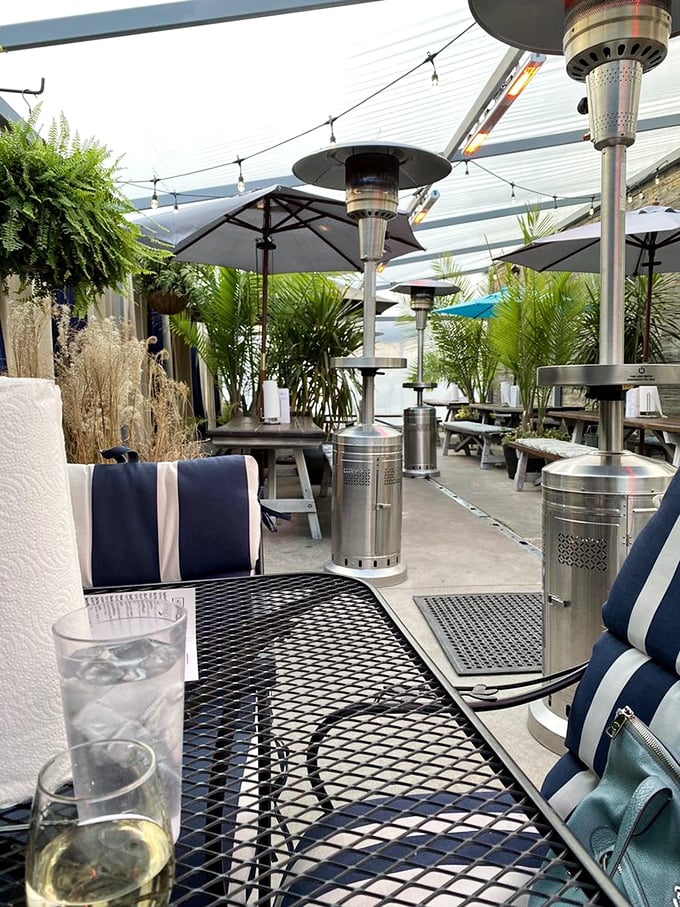 The outdoor patio offers a breezy escape with tropical plants and heat lamps. Coastal vibes in the Ozarks—no sunscreen required.