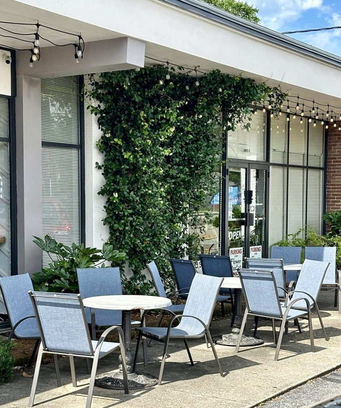 The outdoor seating area, where ivy climbs the walls and Mississippi sunshine turns breakfast into an event worth attending.