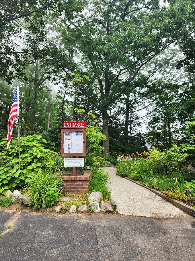 The entrance pathway beckons visitors with lush greenery and colorful flowers. Nature's red carpet leading to a stone masterpiece.