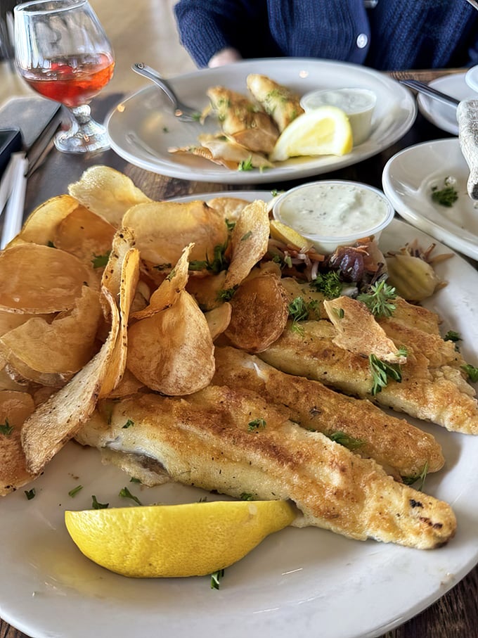 Golden perch fillets with house-made chips—the Midwest's answer to fish and chips. That lemon wedge isn't just garnish; it's the perfect finishing touch.