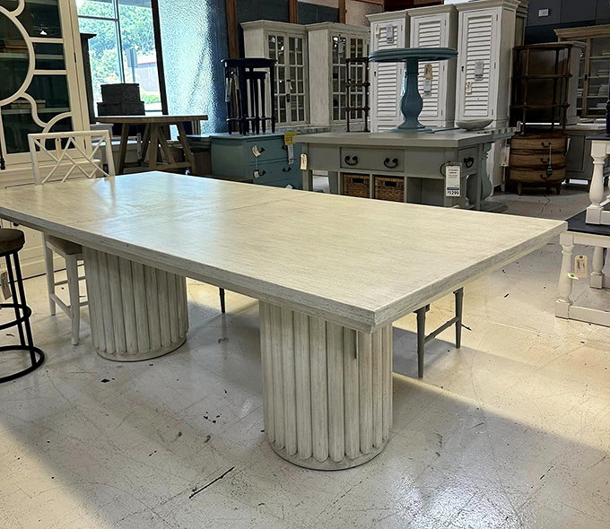 A coastal-inspired dining table with fluted column bases that would make ancient Greeks nod in approval while reaching for the spanakopita.