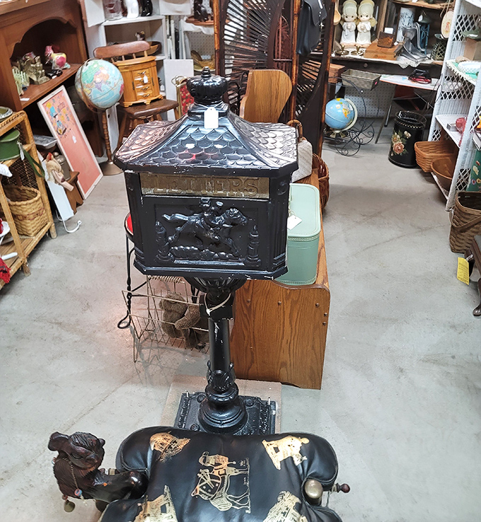 An antique mailbox stands sentinel among globes and wooden treasures. Letters may have gone digital, but nostalgia never loses its stamp.