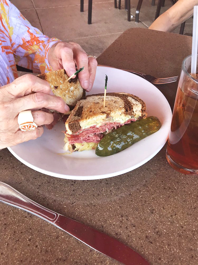 The Reuben sandwich&mdash;where corned beef, sauerkraut, and Swiss cheese meet in a grilled marble rye summit that demands to be eaten with both hands.