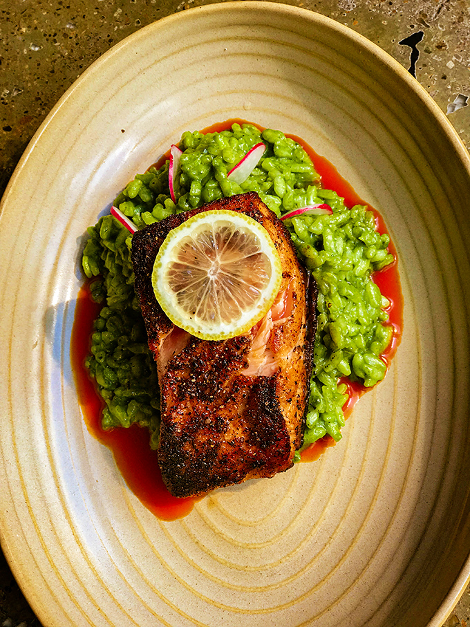 Perfectly seared salmon atop vibrant green rice&mdash;a dish that proves Mexican cuisine extends far beyond the taco stand.