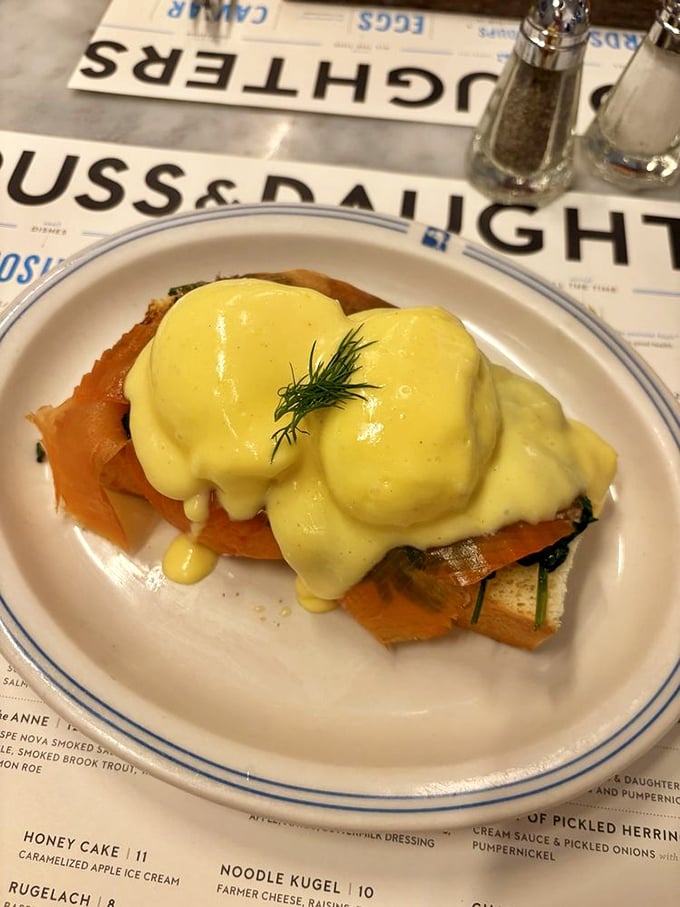 Eggs Benedict reimagined through a Jewish lens &ndash; hollandaise cascading over smoked salmon like a silky yellow waterfall.