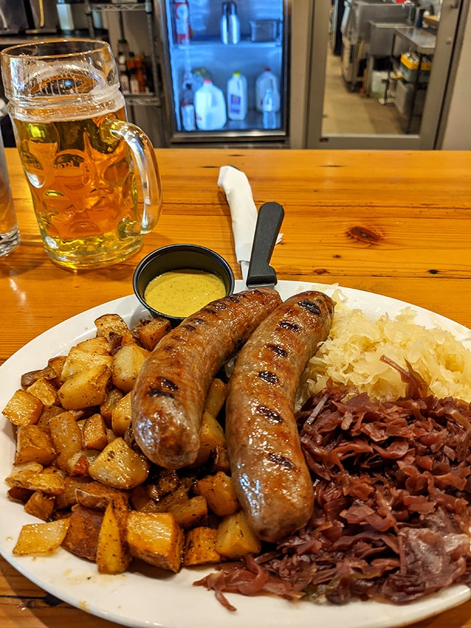Two sausages walk into a bar... and end up on this plate with potatoes and sauerkraut that's been fermenting since your last birthday.