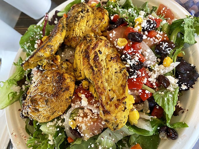 A southwest chicken salad that bridges cultures&mdash;grilled seasoned chicken resting atop a vibrant garden of veggies, cheese, and Mediterranean touches.