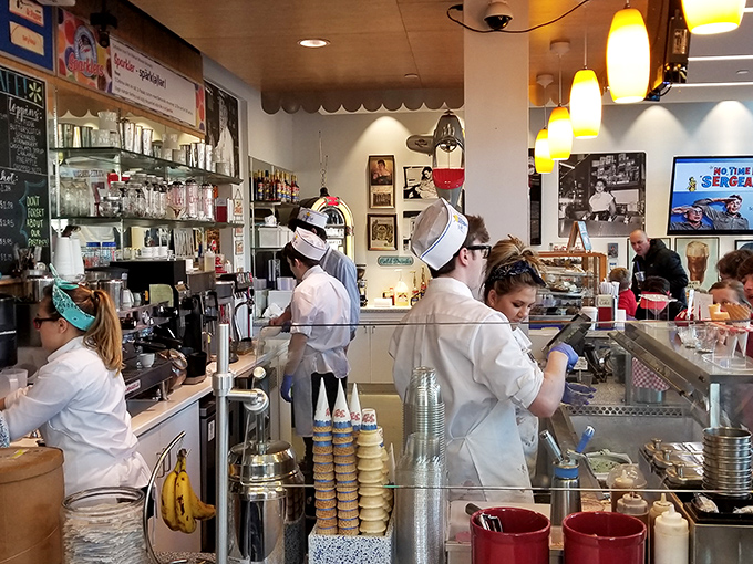 The white-uniformed staff moves with choreographed precision, each scoop and swirl backed by training that transforms dairy into dreams.