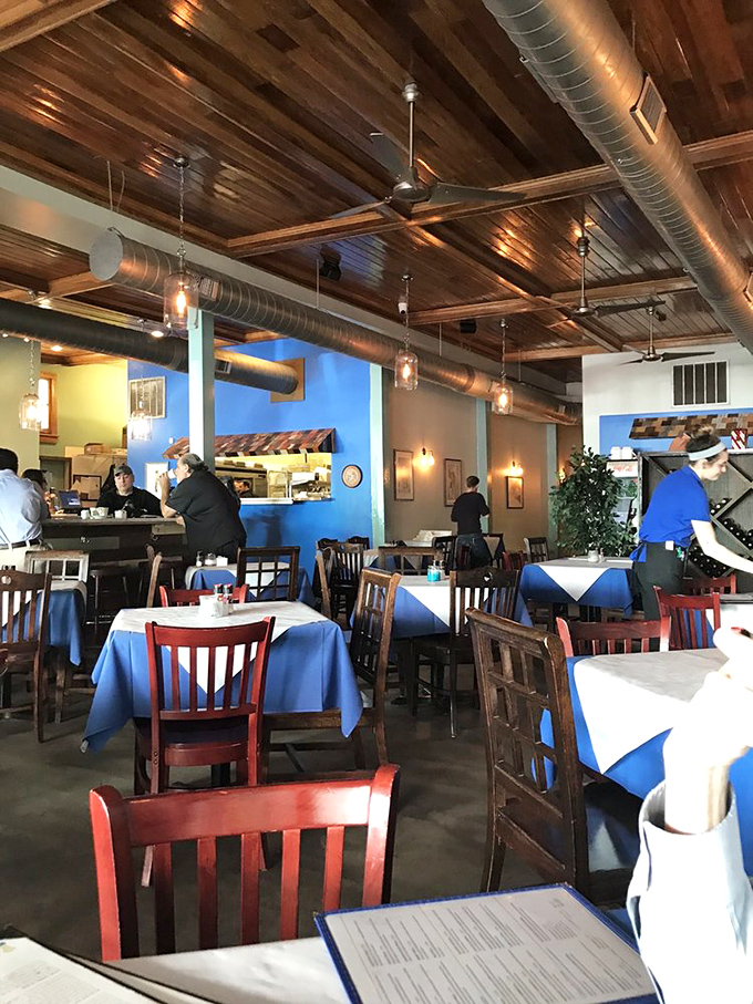 The blue walls and wooden ceiling create a space that feels both rustic and refined, like dining in a seaside taverna that's been transported to Louisiana.