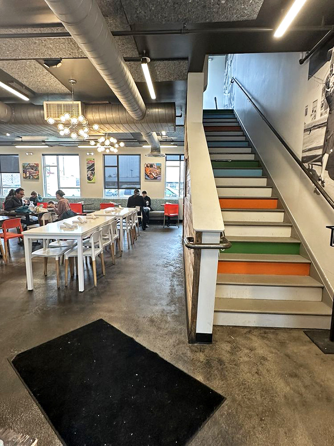 Colorful stairs leading to breakfast heaven &ndash; each step bringing you closer to rooftop dining with a side of Denver skyline.