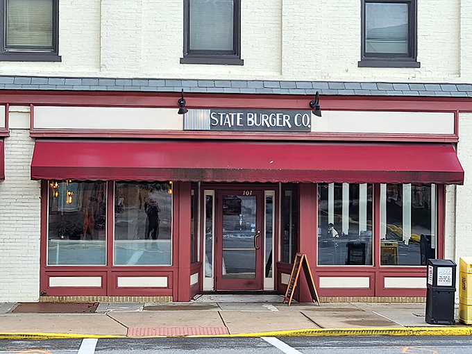 State Burger Co's classic storefront promises the kind of straightforward, no-nonsense burgers that fuel serious antique expeditions. The red awning is just a bonus.