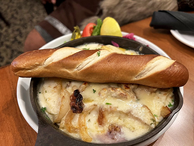 This bubbling cauldron of Swiss cheese magic comes with its own bread boat, ready to sail you straight to dairy paradise.