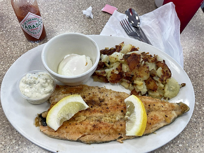 Trout that tastes like it just decided to jump onto your plate, with lemon wedges standing by for those who need a citrus security blanket. 