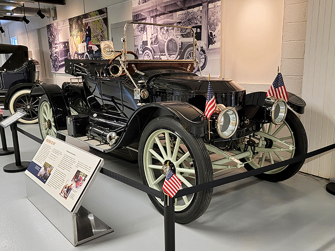 Flags flutter proudly on this stately black automobile, a presidential-worthy chariot from days when hitting 20 mph felt like flying.