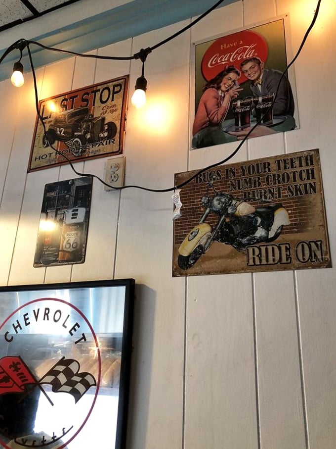 The walls tell stories of American road culture—vintage signs and string lights creating the perfect backdrop for roadside dining nostalgia.