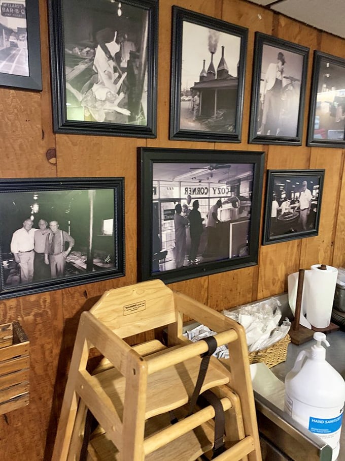The wall of fame tells stories that menus can't. Each photo frame holds a chapter in the gospel according to smoke and fire.