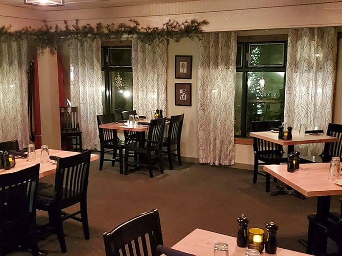 Holiday touches transform this corner into an intimate retreat where white tablecloths signal "something special happens here" without whispering a word.