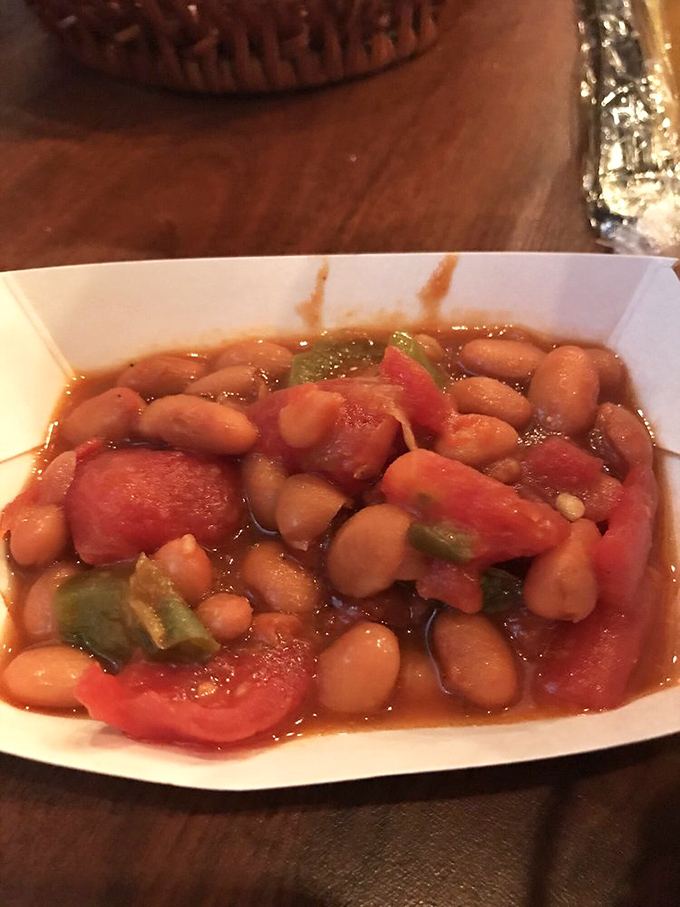 Baked beans swimming in sweet, smoky sauce that makes you wonder why anyone bothers with the canned variety.