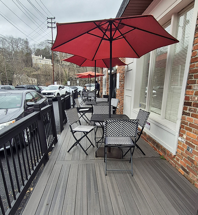 Front porch dining with those signature red umbrellas—where your breakfast comes with a side of people-watching and gentle Maryland breezes.