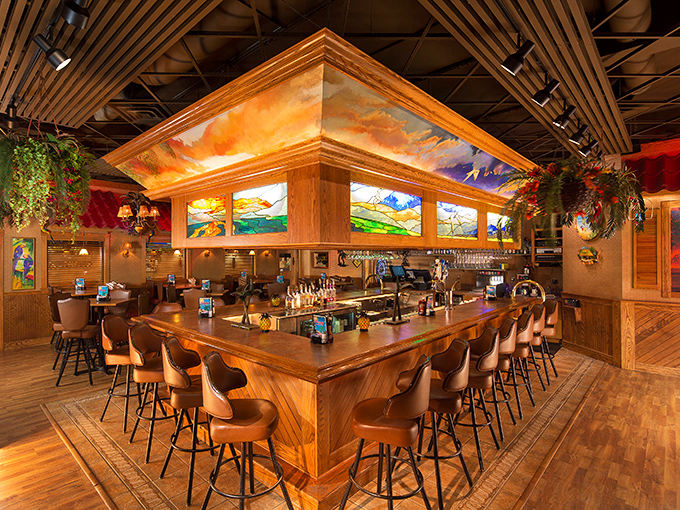 The bar area looks like it was designed by someone who understands that good drinks and sunset-colored lighting make everyone look ten years younger.