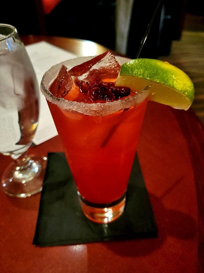 This cocktail isn't just a drink; it's a sunset in a glass, complete with a salt-rimmed horizon and a lime wedge standing in for the moon.