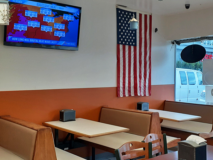 Where weather reports and donut consumption happen simultaneously. That orange wall has heard more local news and gossip than the town newspaper.