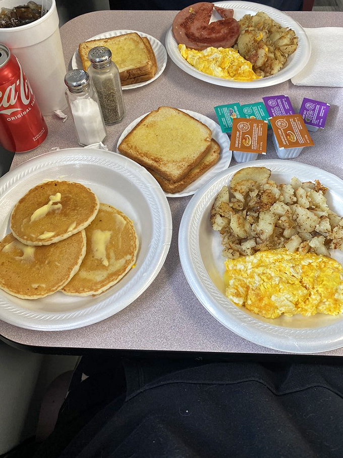 Breakfast spread that would make a rooster crow with delight. Those pancakes are living their best buttery life.