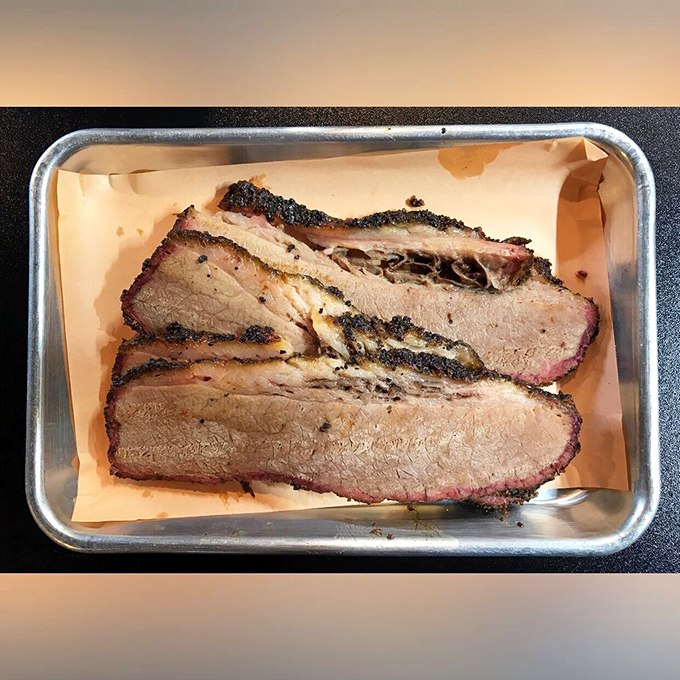 Brisket sliced thick enough to show off that perfect pink smoke ring. This isn't just meat&mdash;it's a time capsule of patience and wood smoke. 