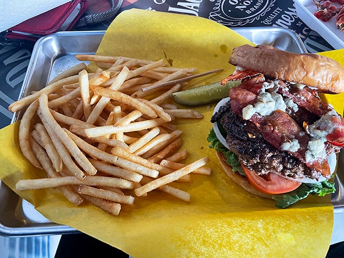 This burger and fries combo isn't just a meal—it's a statement piece served on yellow paper, no plate required for this rebel.