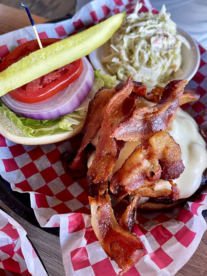 A burger that requires both hands and extra napkins is always a good sign. That pickle spear standing at attention is practically saluting your good taste.