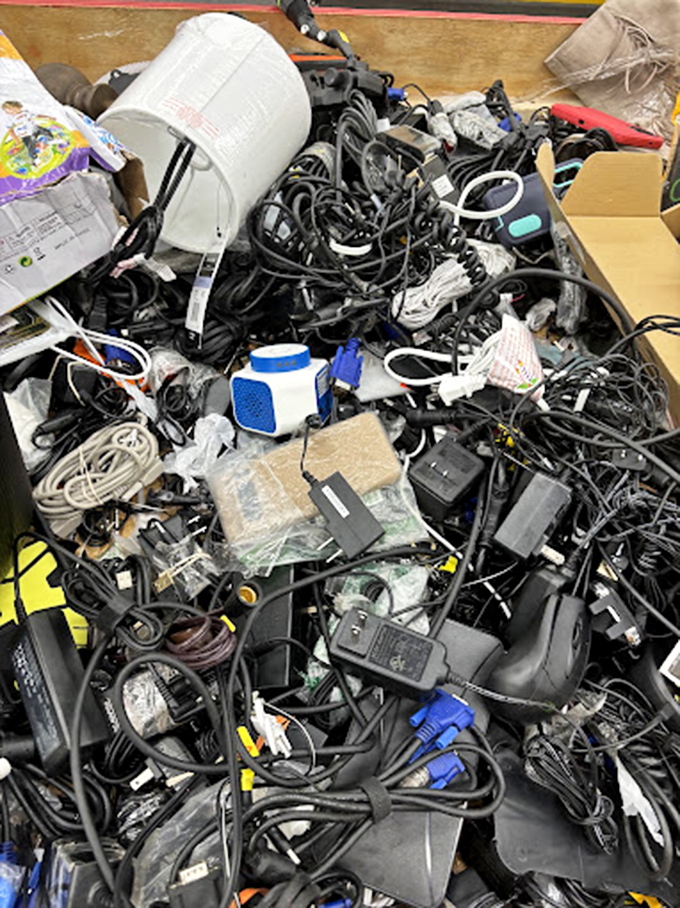 The cable bin&mdash;a tangled testament to modern life where somewhere in this technological spaghetti lies exactly the charger you need.