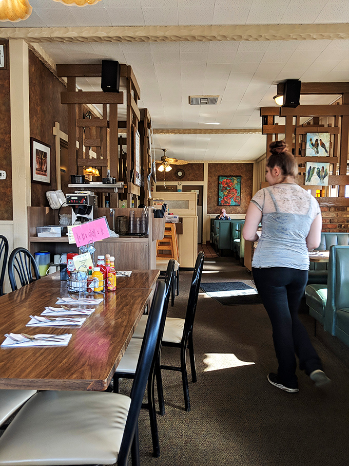 Wooden dividers and warm lighting create dining "rooms" within the room&mdash;architectural features that say "stay awhile" better than any neon "open" sign ever could.