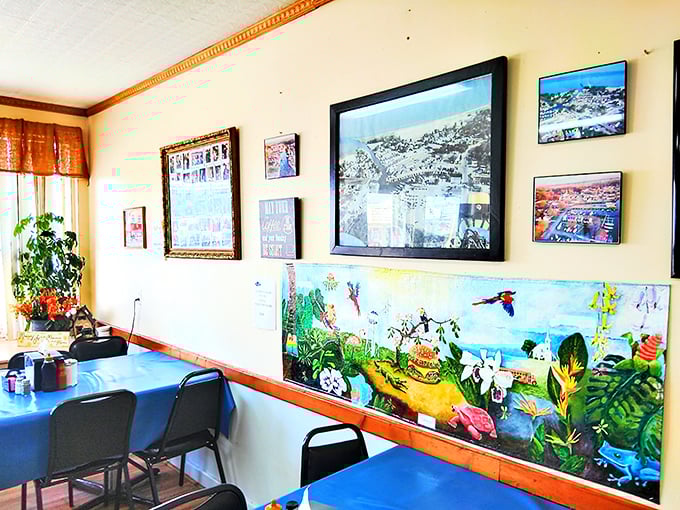 Wall art that tells stories of local pride, with blue tables below creating the perfect stage for breakfast theater. No tickets required.
