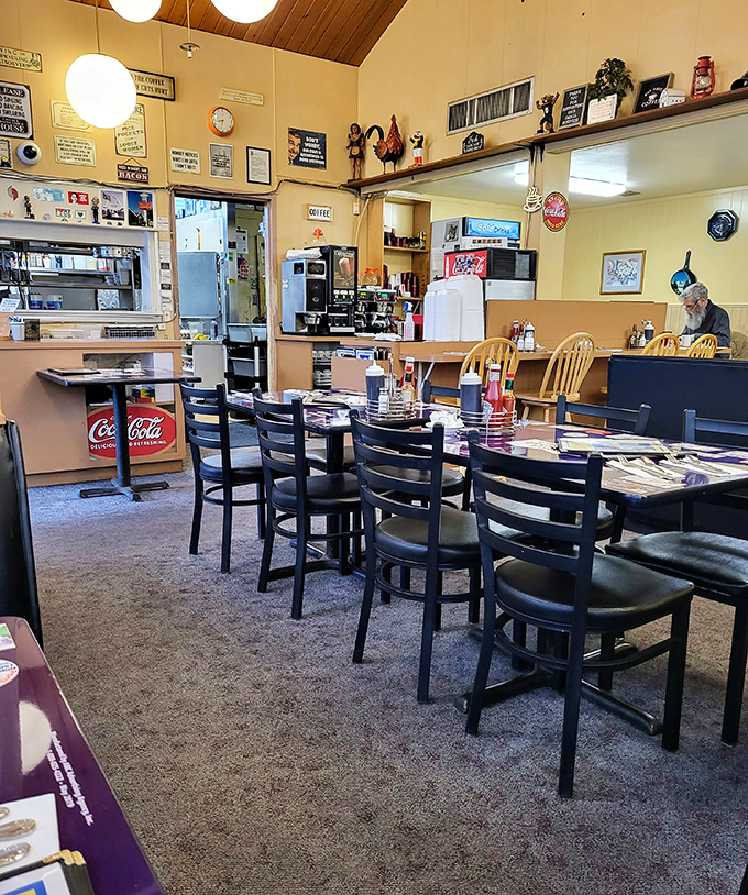 The dining room says, "Stay awhile, have another cup." Black chairs, laminated menus, and conversations that matter more than the decor.