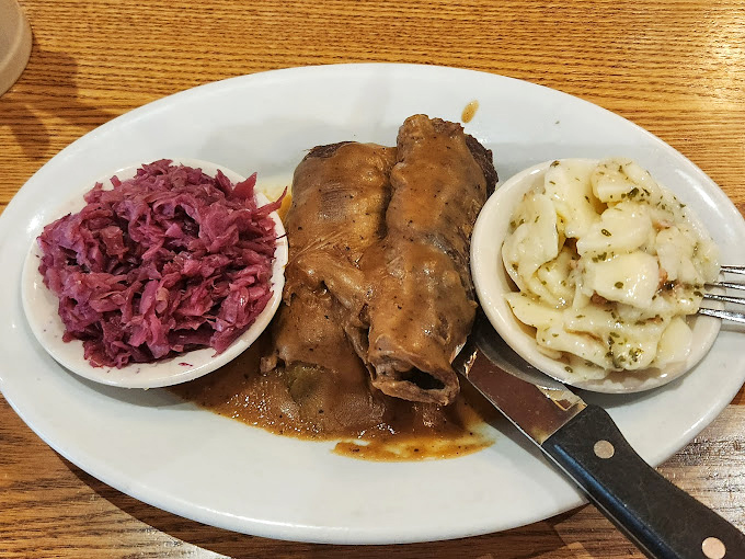 The star of our show: German potato salad in its natural habitat, served warm with herbs and bacon that make mayonnaise seem like an unnecessary distraction.