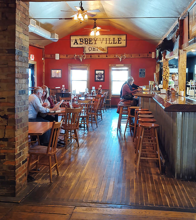 Morning light streams through windows onto wooden floors where diners gather at the altar of smoked meats and craft brews.