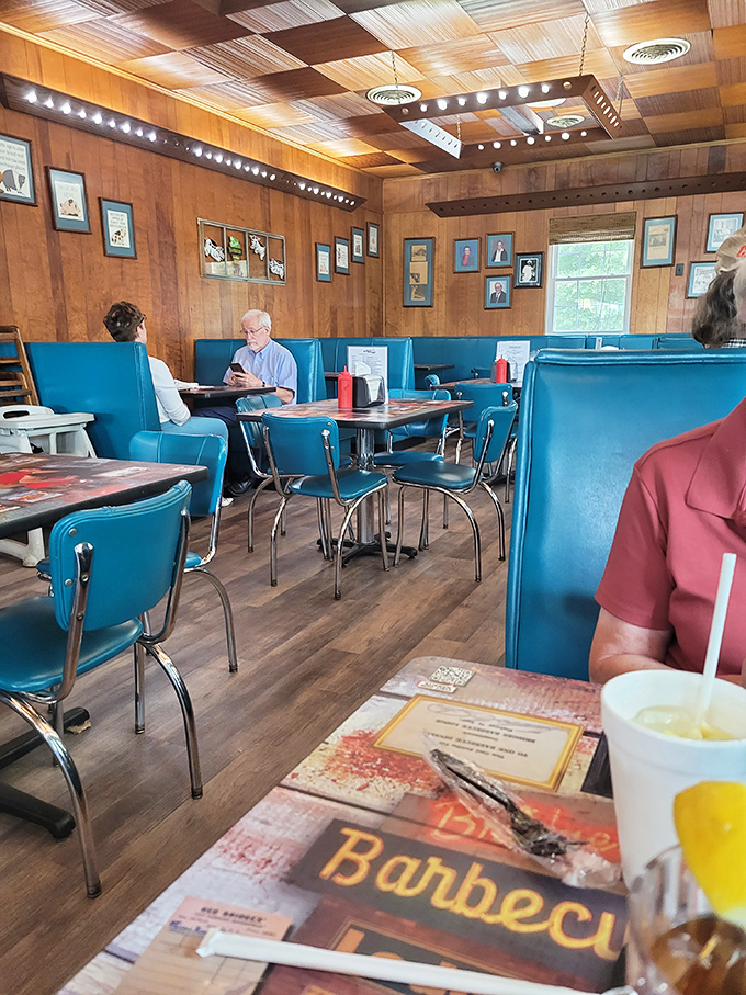 The walls tell stories of decades past while diners create new memories. Every framed photo represents another chapter in Red Bridges' smoky legacy.