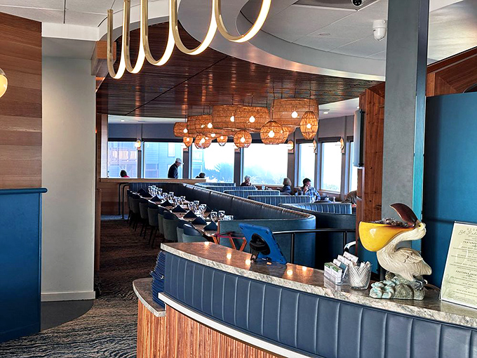 Modern meets maritime in this stylish corner, where terrazzo tables and curved wooden dividers create cozy conversation nooks.