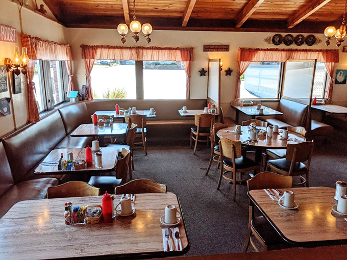 Red-checkered curtains and booth seating create that nostalgic diner atmosphere where calories don't count and coffee refills are endless.