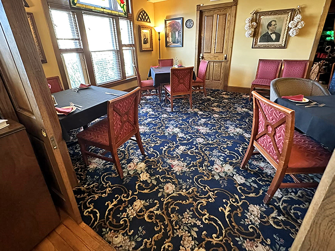 Another elegant dining space where every table feels like the best in the house. The blue floral carpet and coral chairs create a timeless dining atmosphere.