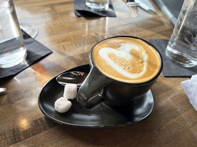 Coffee art that belongs in a museum&mdash;paired with sugar cubes that know they're just supporting actors in this caffeinated drama.