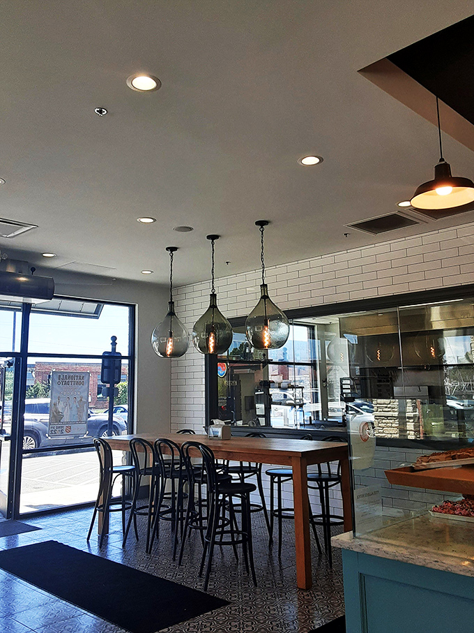 High-top tables and pendant lighting create the perfect perch for donut appreciation. Casual elegance meets sugar-fueled happiness.