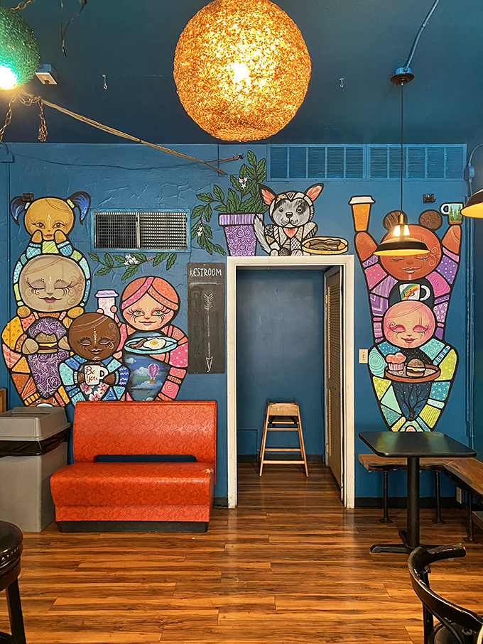 Whimsical murals transform a simple restroom hallway into an unexpected art gallery. Coffee shops with personality are always worth the visit.