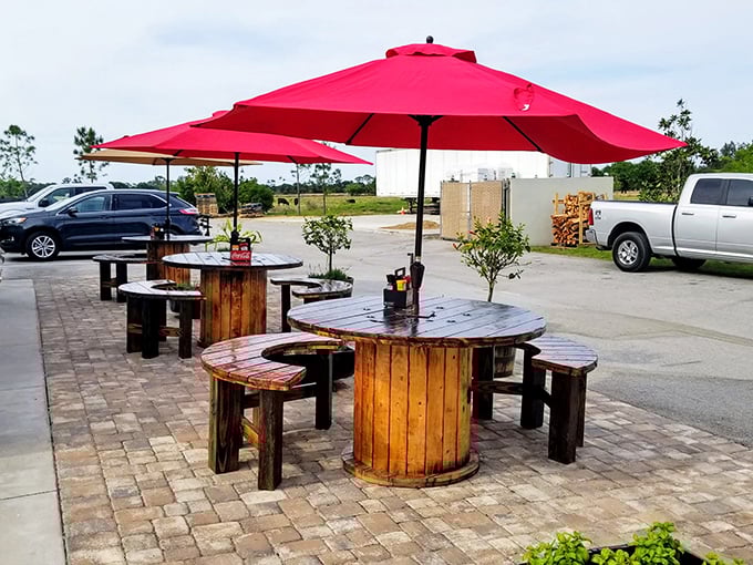 Al fresco dining, Route 66 style. These cable spool tables didn't retire&mdash;they found their true calling under cheerful red umbrellas.
