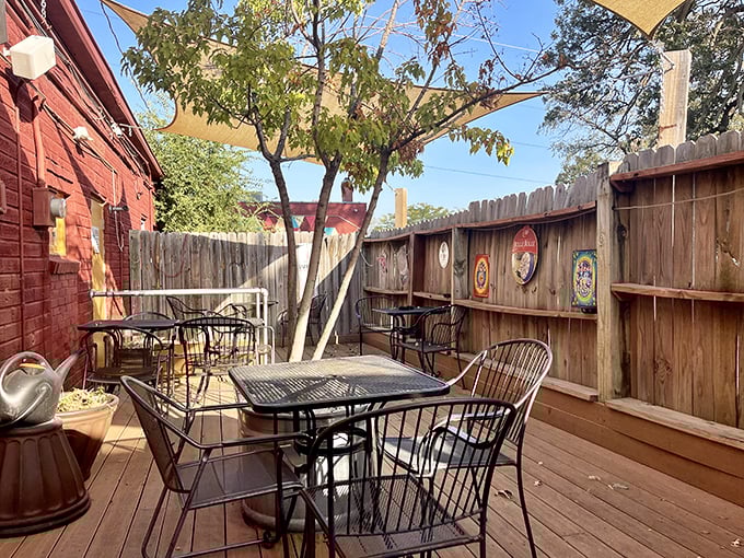 The charming outdoor patio offers a peaceful retreat for seafood enjoyment. Wooden fencing and shade sails create an oasis that feels miles away from everyday life.