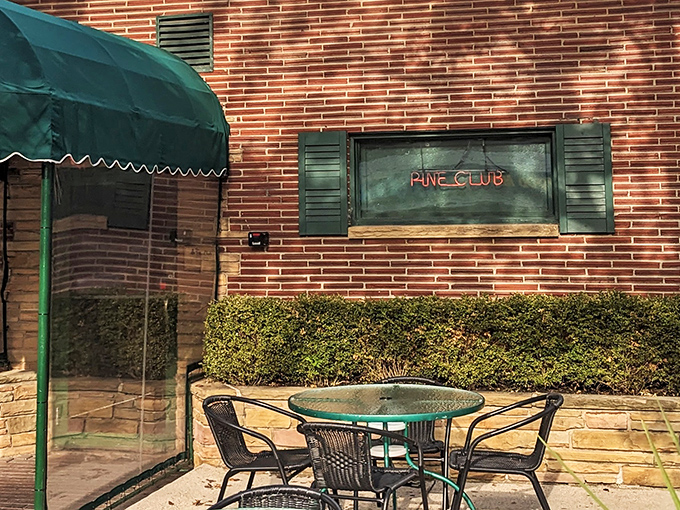 Even the outdoor seating whispers of tradition, offering a moment of fresh air before you step into the warm embrace of beef and bourbon.