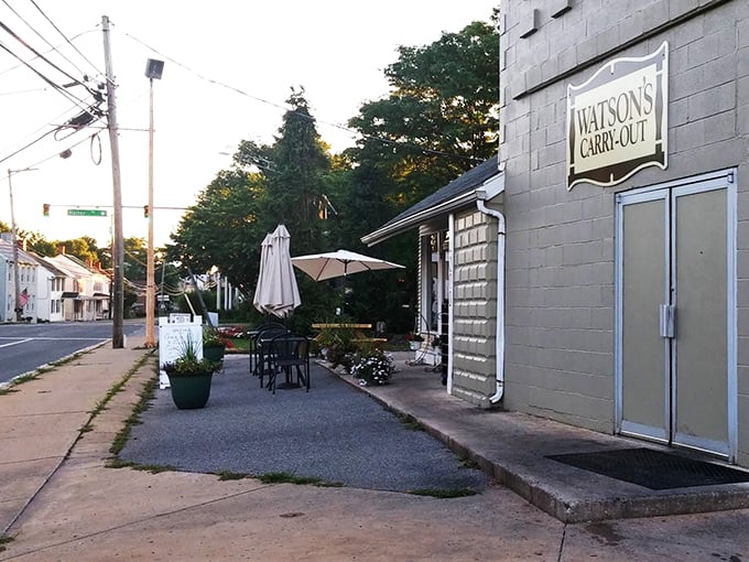 The outdoor seating area offers a charming spot to enjoy your meal al fresco, with the Watson's Carry-Out sign proudly announcing its presence to the neighborhood.
