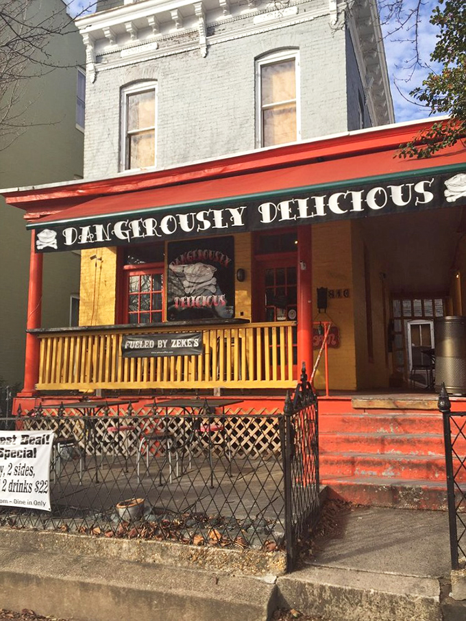 The front porch sports a fresh coat of orange-red paint. "Fueled by Zeke's" sign hints at the local coffee served inside.