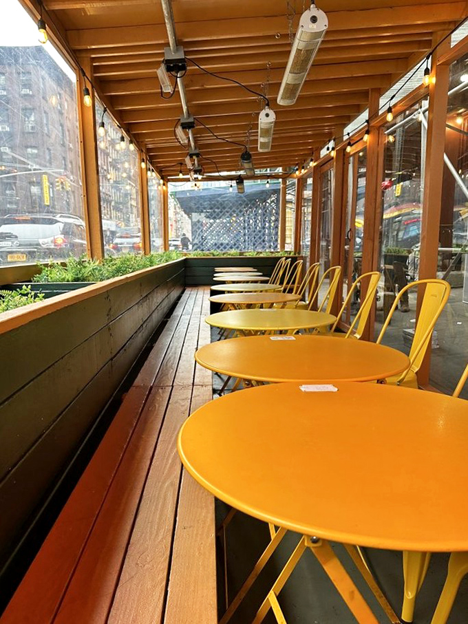The outdoor seating area's cheerful yellow tables offer a sunny disposition, even on cloudy Manhattan mornings.
