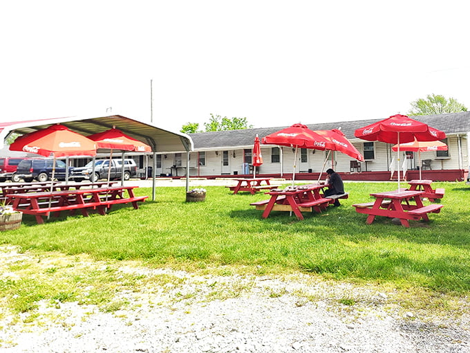When Kentucky weather cooperates, these red picnic tables become the perfect stage for the messy, wonderful theater of outdoor barbecue dining.